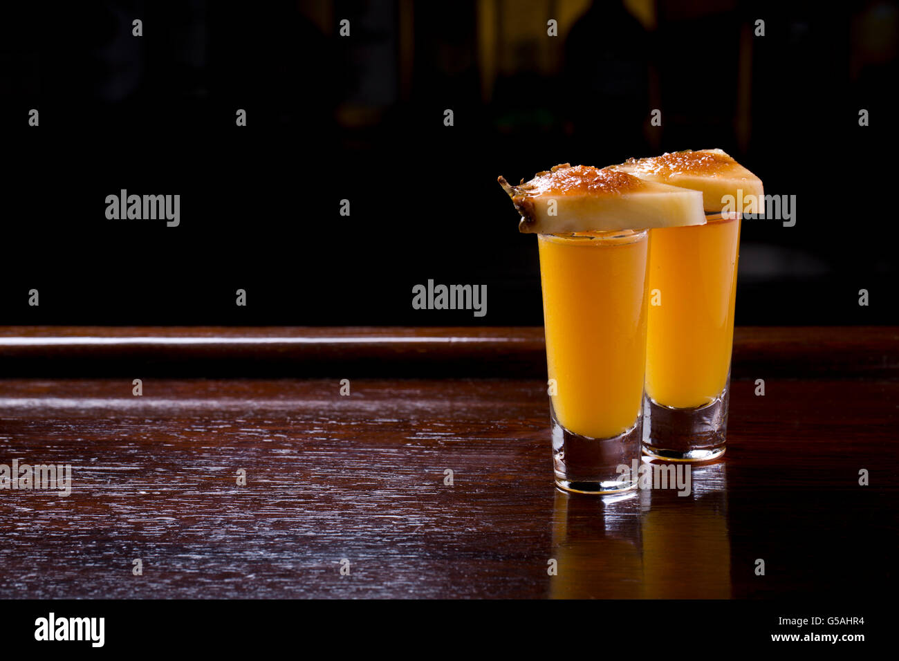 Tasty mango alcohol shots with pineapple and brown sugar Stock Photo ...