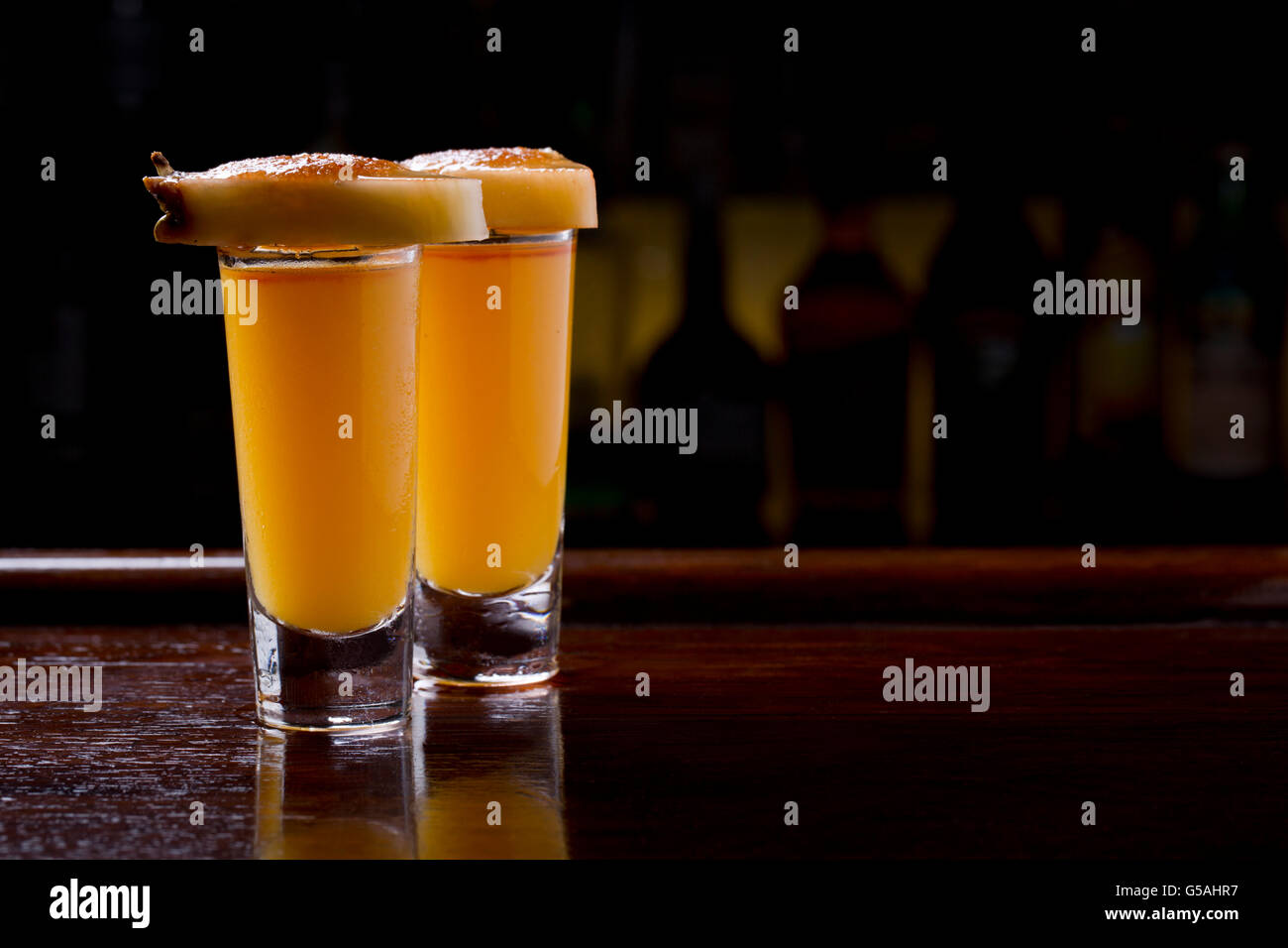 Tasty mango alcohol shots with pineapple and brown sugar Stock Photo ...