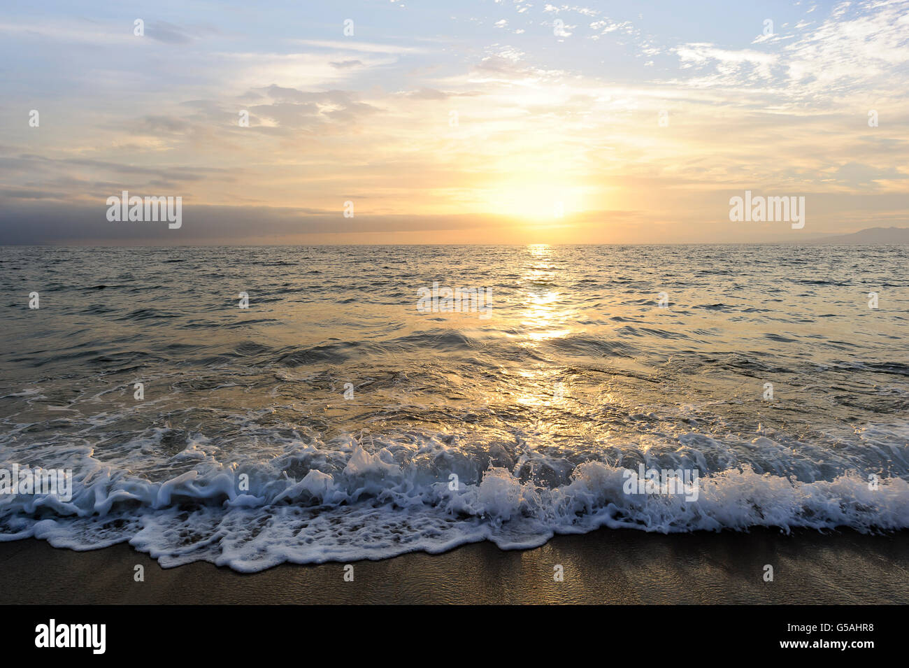Ocean sunset is a brightly lit golden seascape with a gentle wave ...