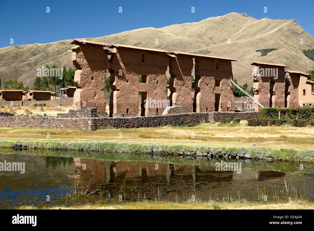 Brick walls of temple reflected on pond, Inca ruins, Raqchi, Cusco ...