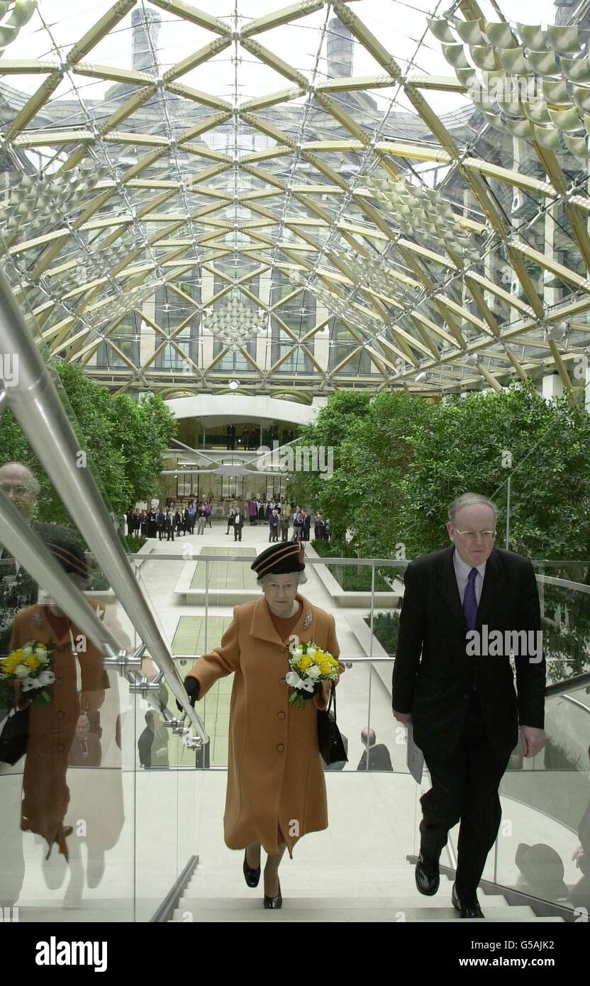 Britain's Queen Elizabeth II walks up steps from the atrium, with Mr ...