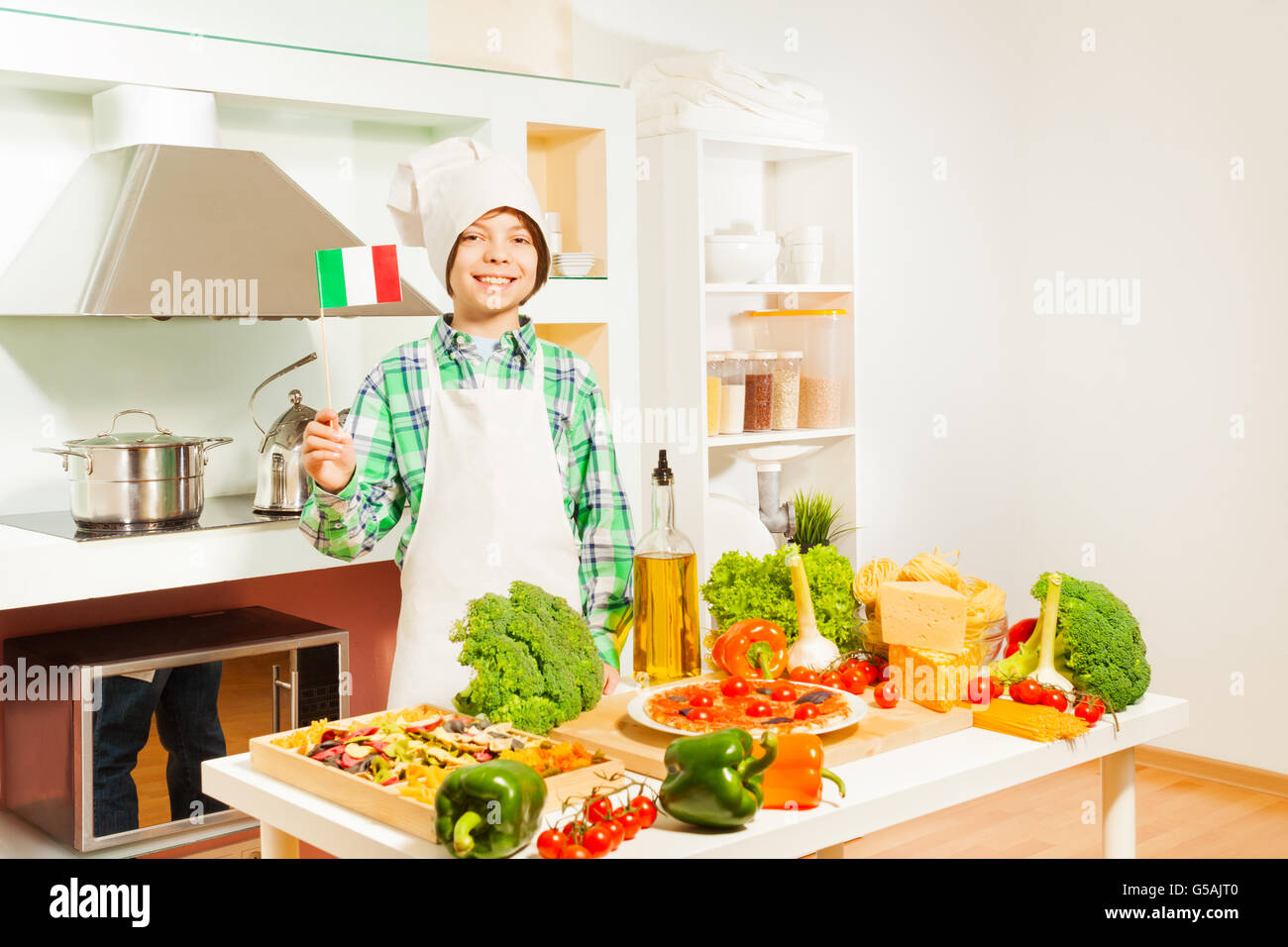 Happy Italian boy in cook's uniform smiling Stock Photo - Alamy