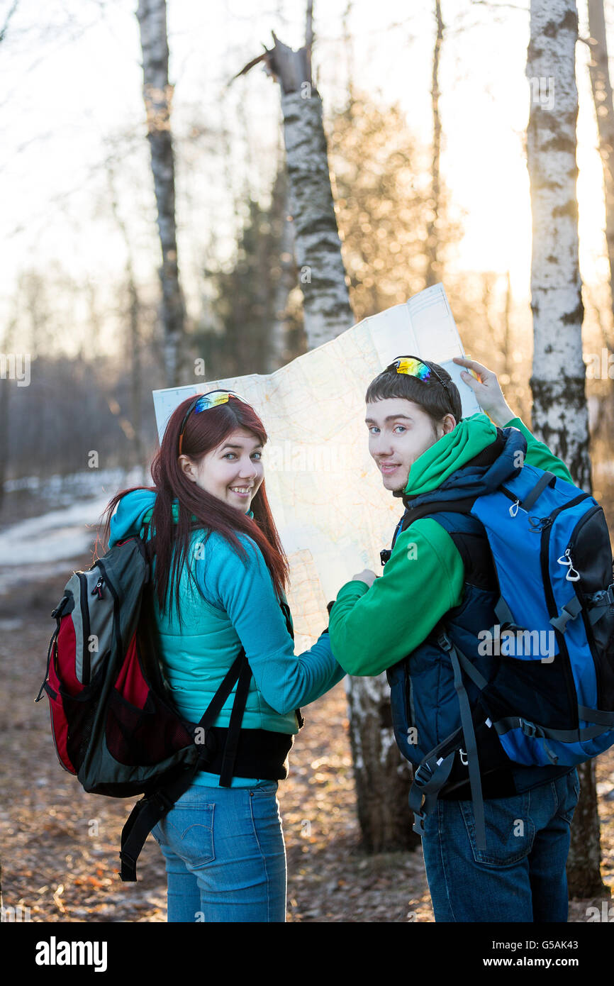 Young couple hikers looking at map Stock Photo - Alamy