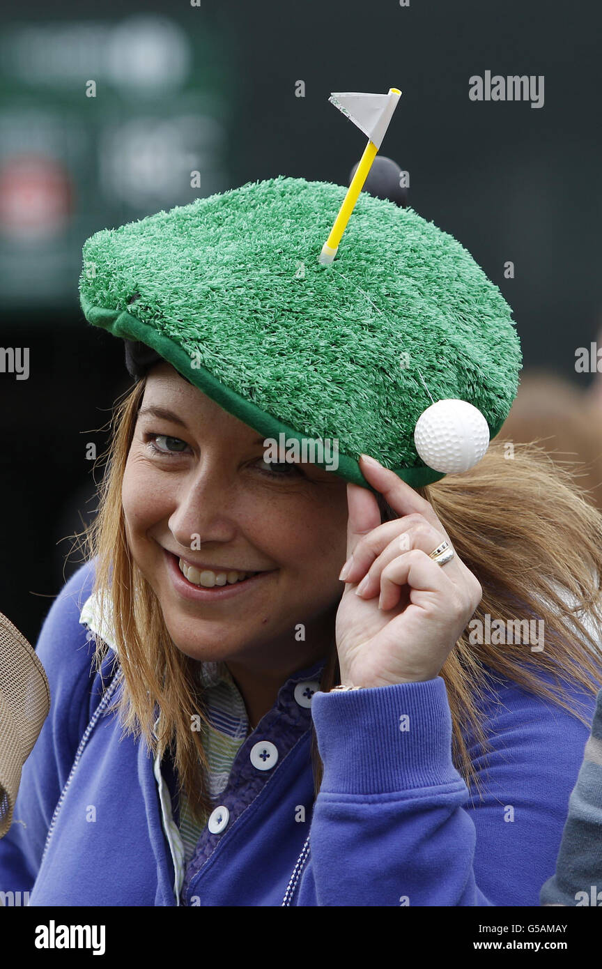 A golf fan wears a hat in the design of a green during day two of the ...