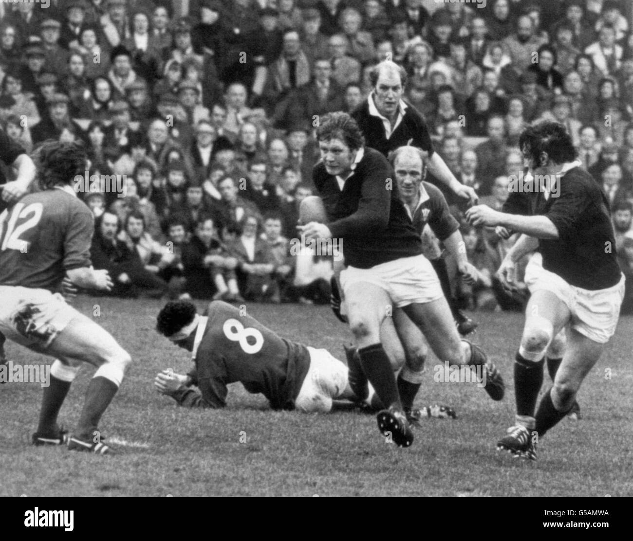 Scotland's Gordon Brown evades a tackle from Wales' Mervyn Davies (No.8 ...