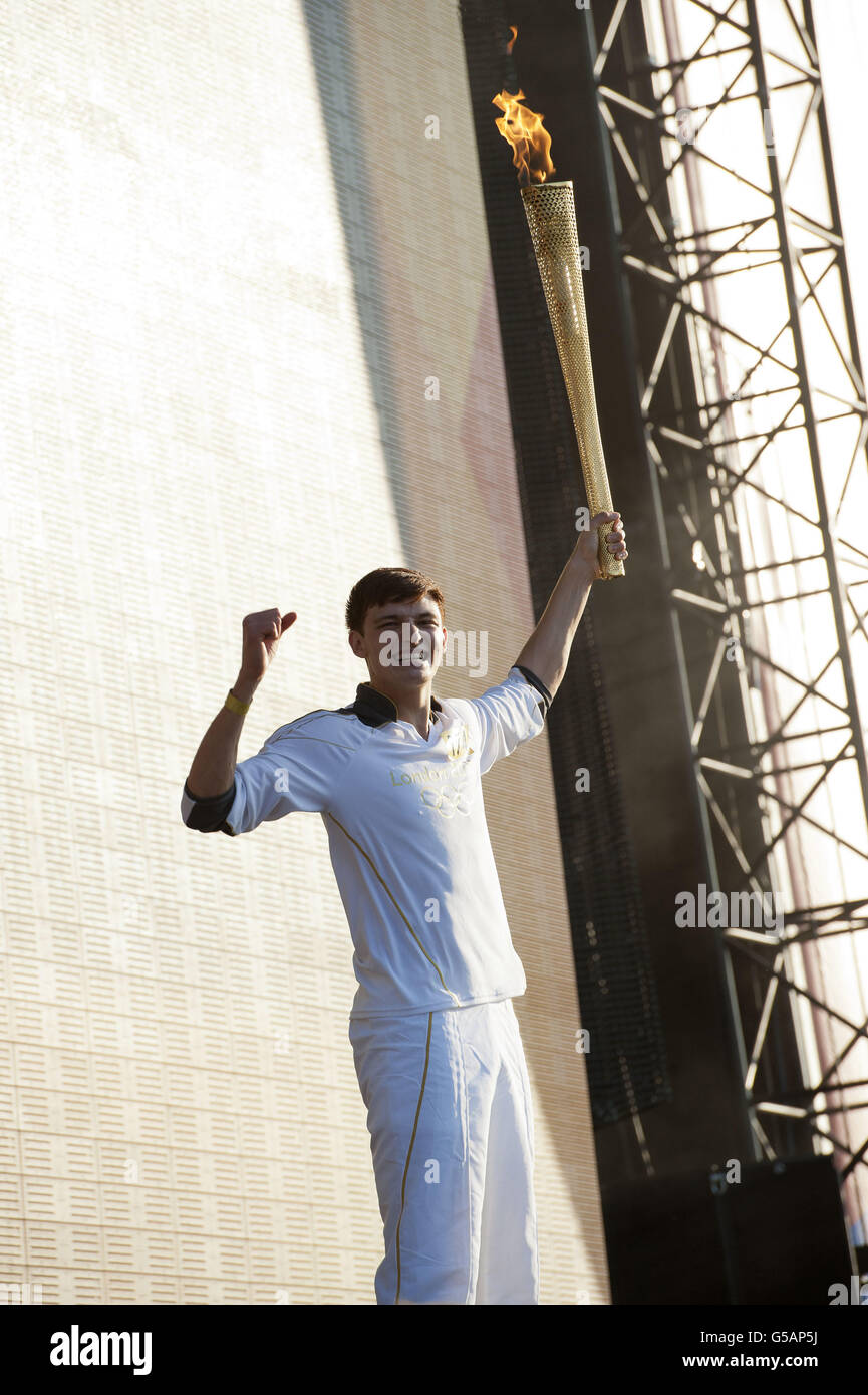 Future Flame Tyler Rix carries the Olympic Olympic Flame on stage at ...