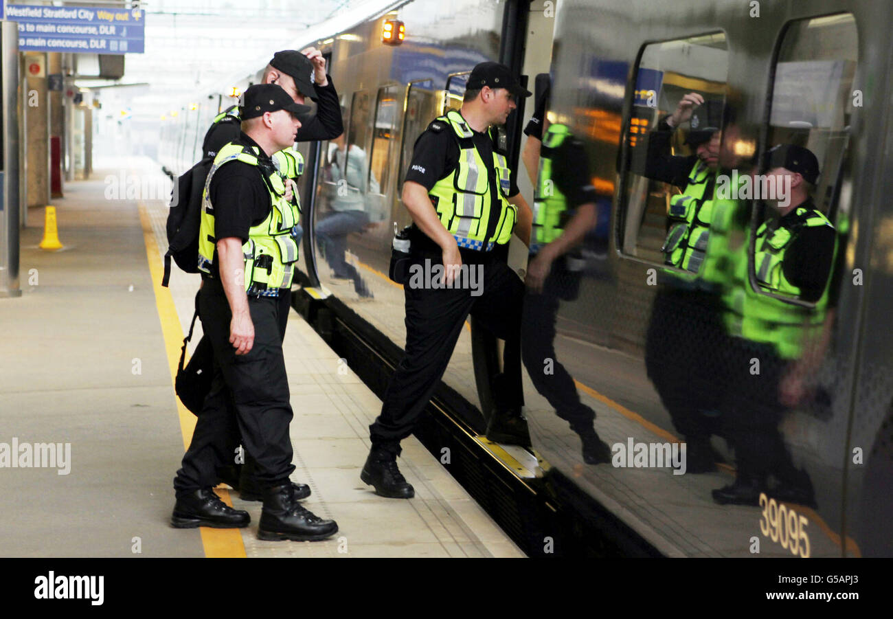 Police officers board a high-speed Javelin train serving the Olympic ...