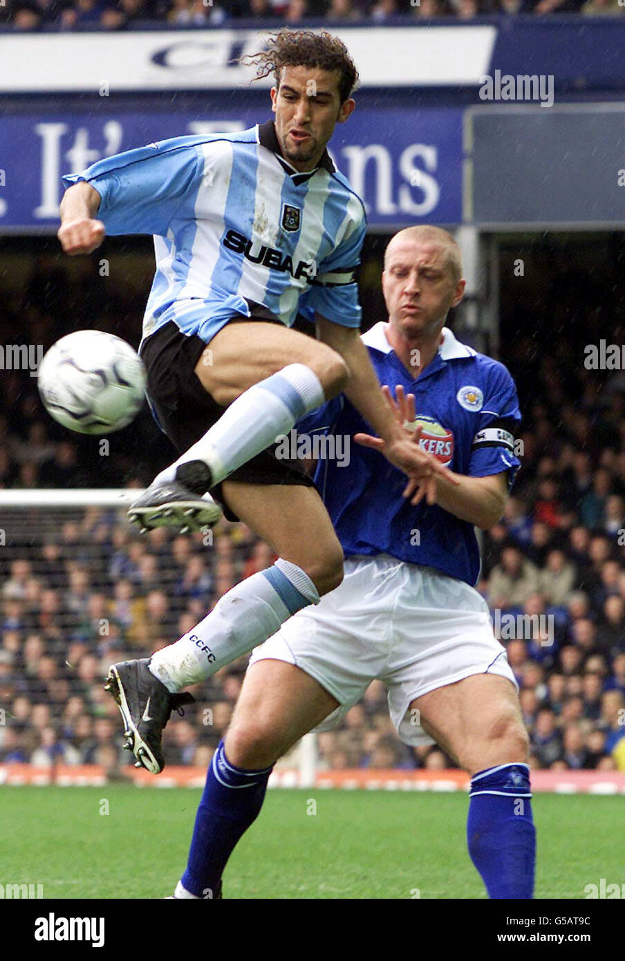 Coventry City's Moustapha Hadji (mid-air) in action with Leicester City ...