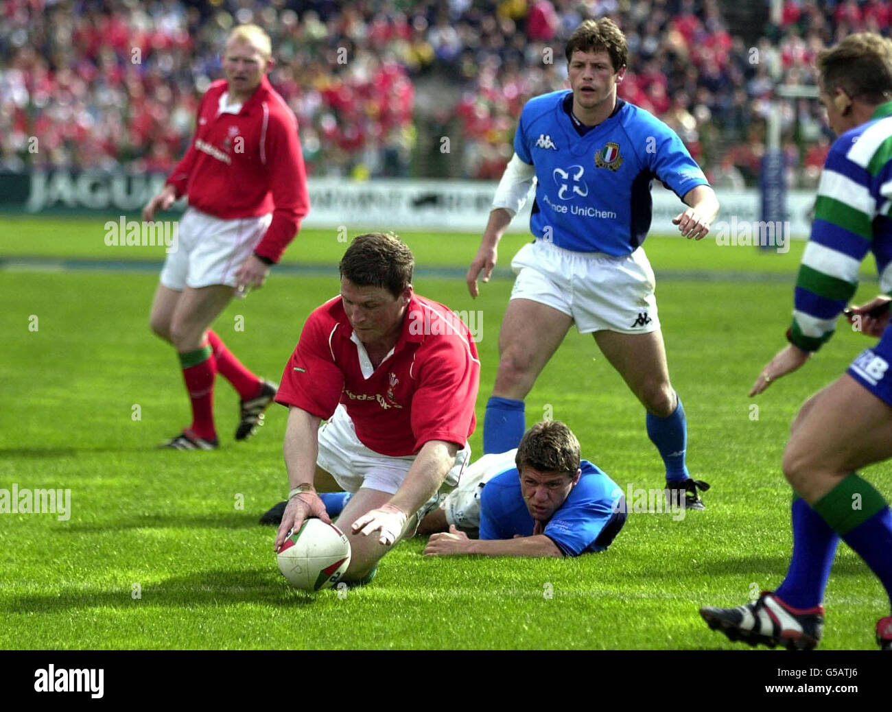 Wales' Scott Gibbs (second left) scores a try against Italy during the ...