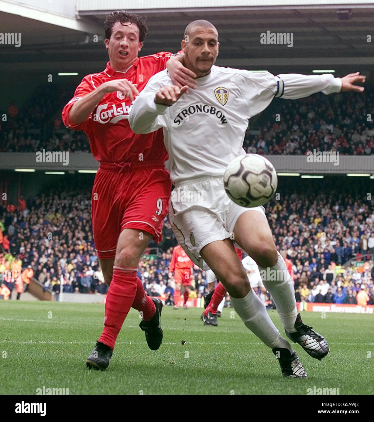 Liverpool striker Robbie Fowler (left) tangles with Leeds United's Rio ...