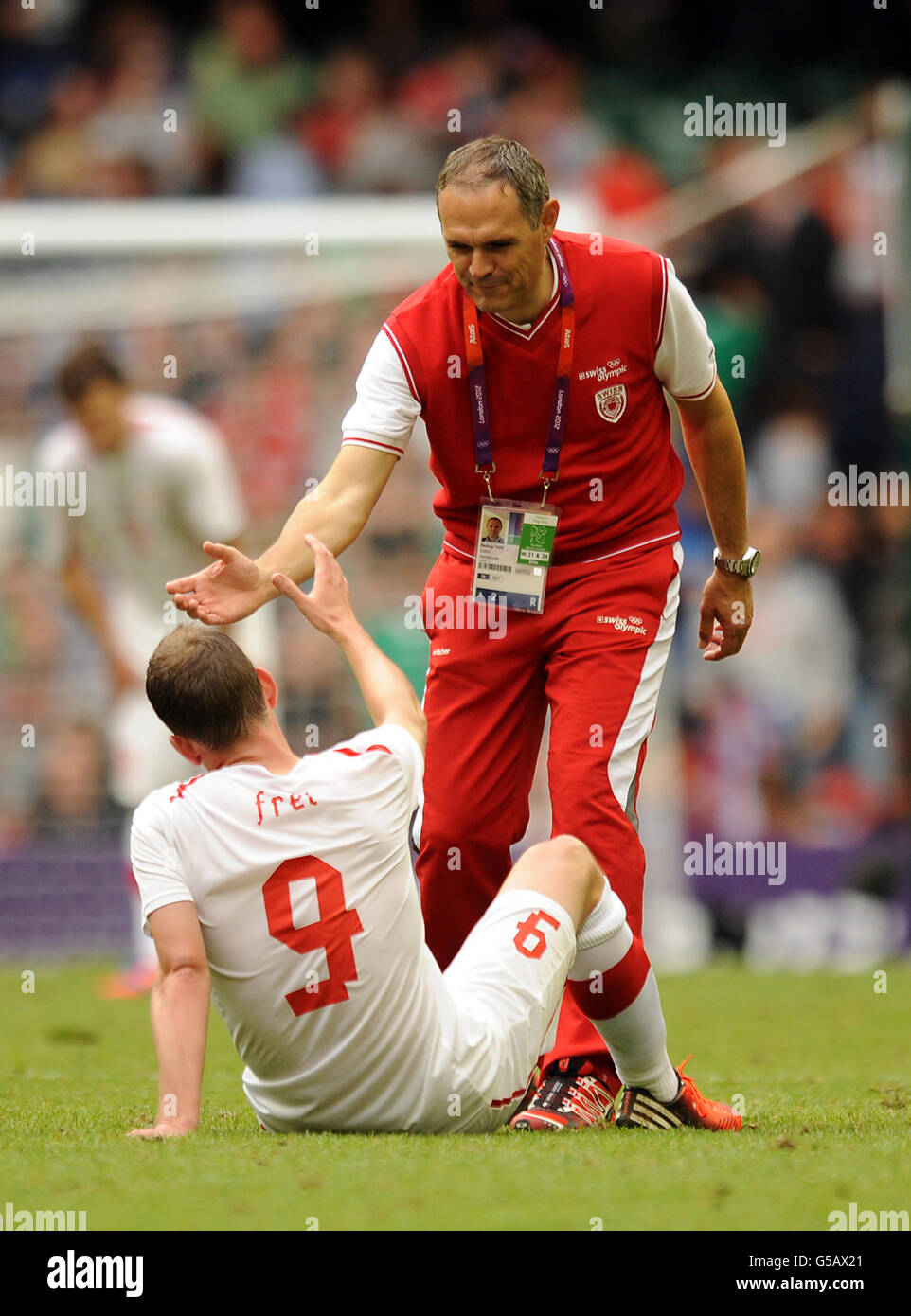 Switzerland head coach Pierluigi Tami offers his hand to Fabian Frei ...