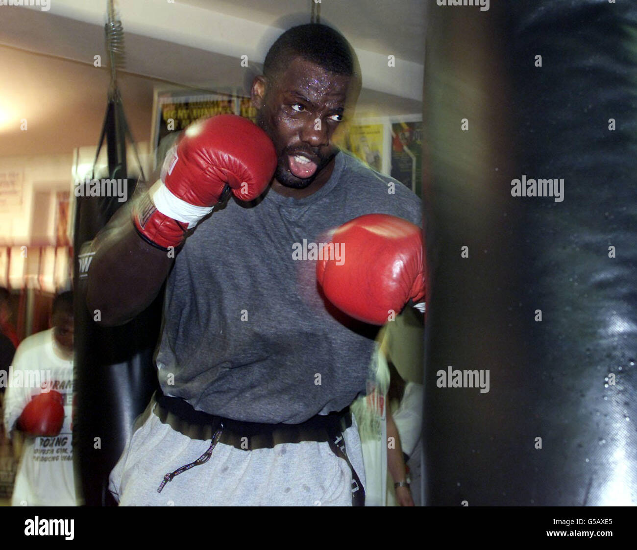 Heavyweight boxer Hasim Rahman trains on the heavy punchbag at Nick ...