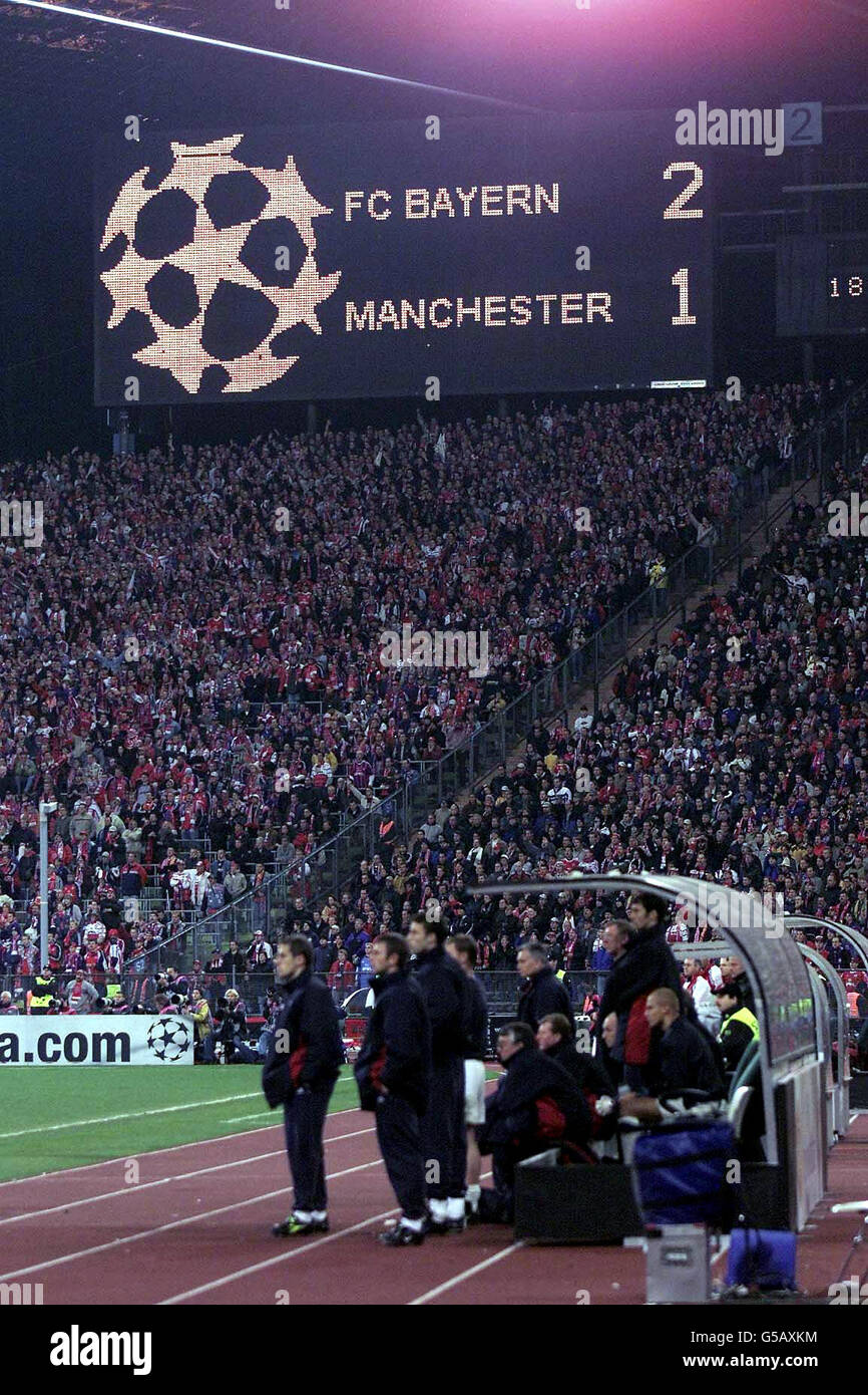 The Manchester United bench sit underneath the scoreboard, showing ...