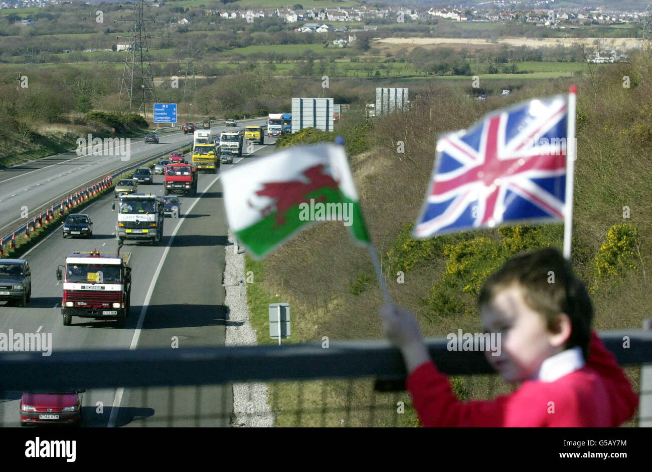 A boy waves the Union Jack and the Welsh flag to support hauliers ...