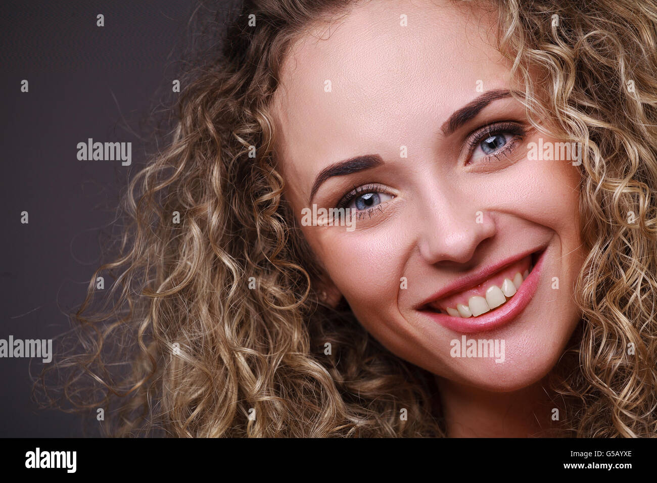 Portrait of curly woman Stock Photo - Alamy