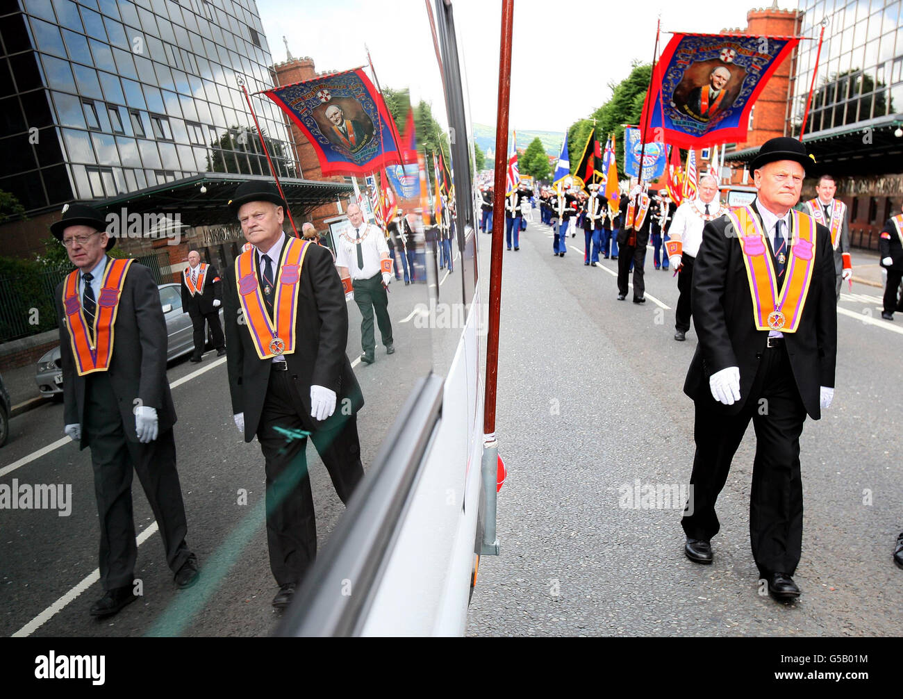 Orange order men seen mirrored in glass parade through belfast hi-res ...