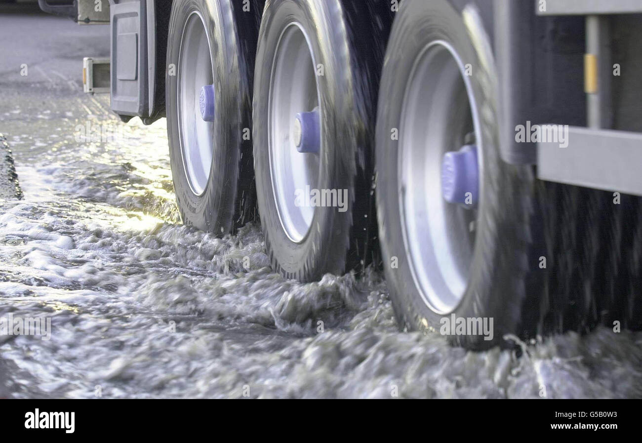 The wheels of a French lorry pass through a disinfectant wheel wash ...