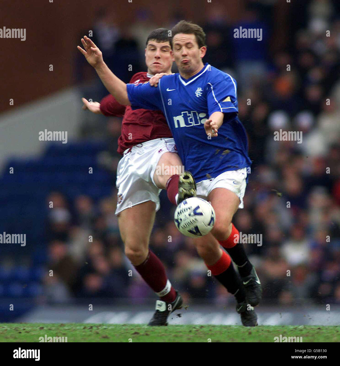 Hearts' Austin McCann and Rangers' Billy Dodds (R) go for the ball ...