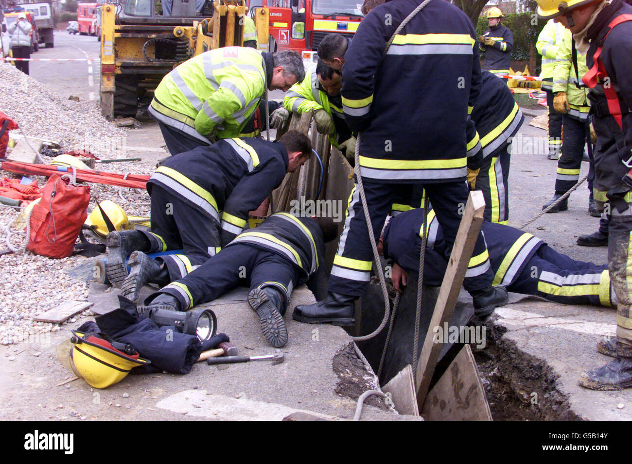 Firemen in the process of lifting a 38-year-old man from a trench he ...