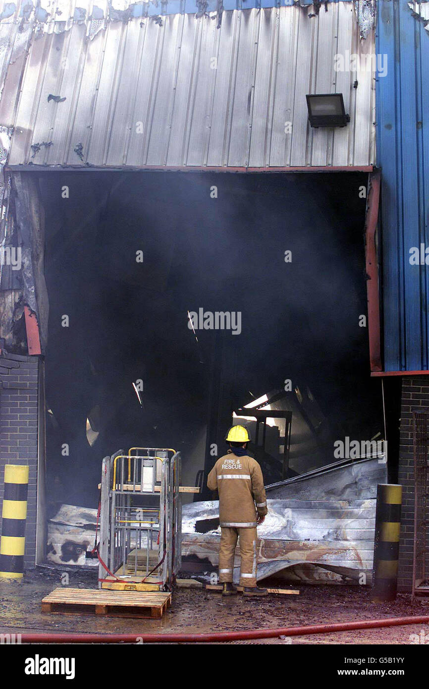 A fireman at the burnt out shell a warehouse in the Ideal World ...