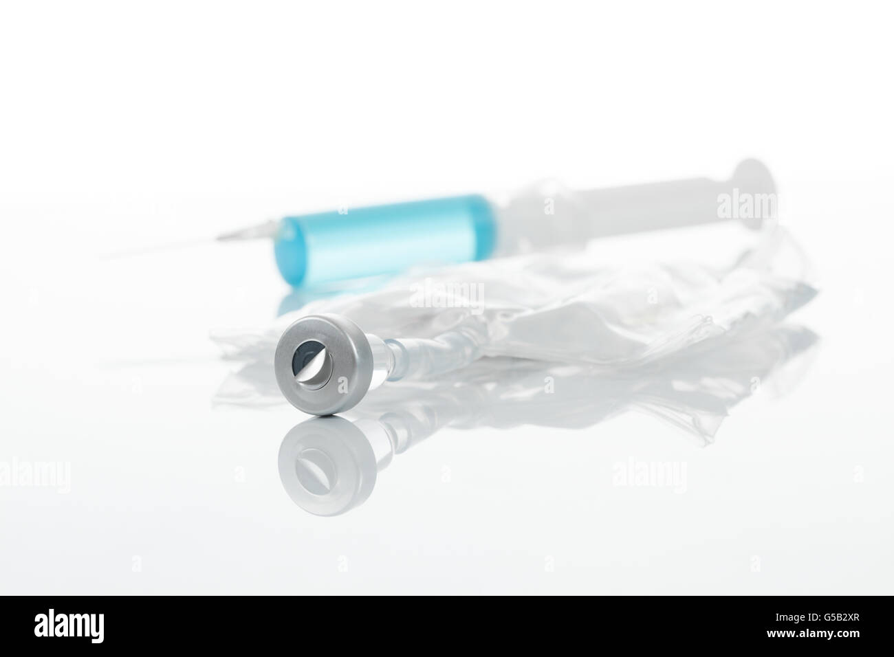 Medical syringe over container with medication - studio shot Stock ...