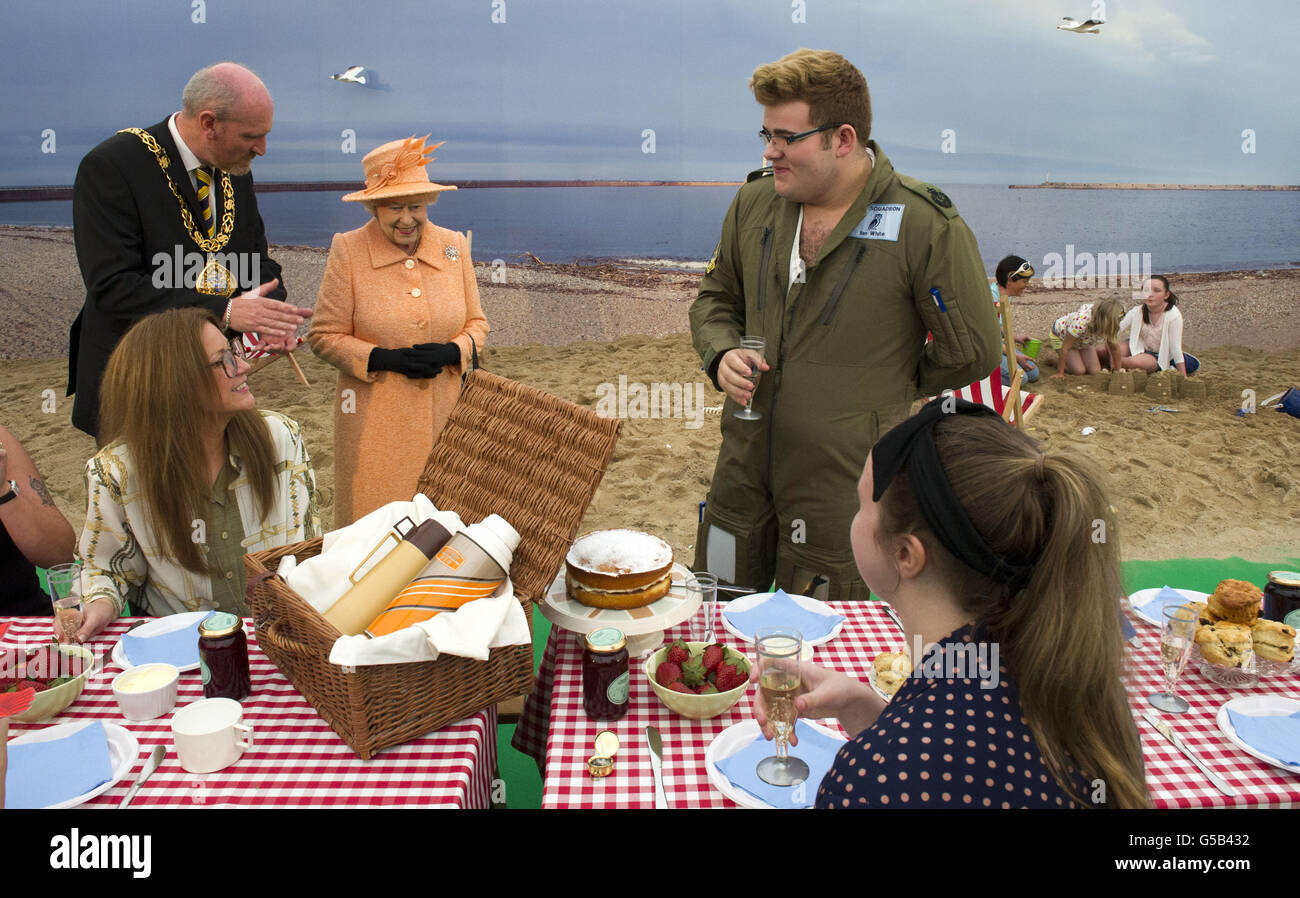 Queen Elizabeth II views a beach scene as she tours a Diamond Jubilee ...