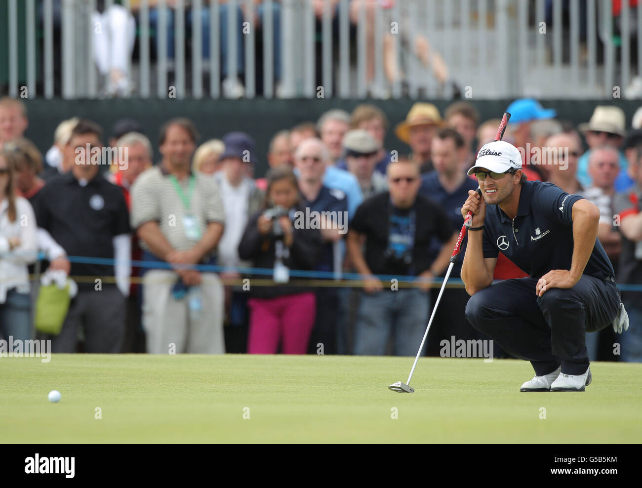 Australia's Adam Scott lines up a putt on the 4th green during day four ...
