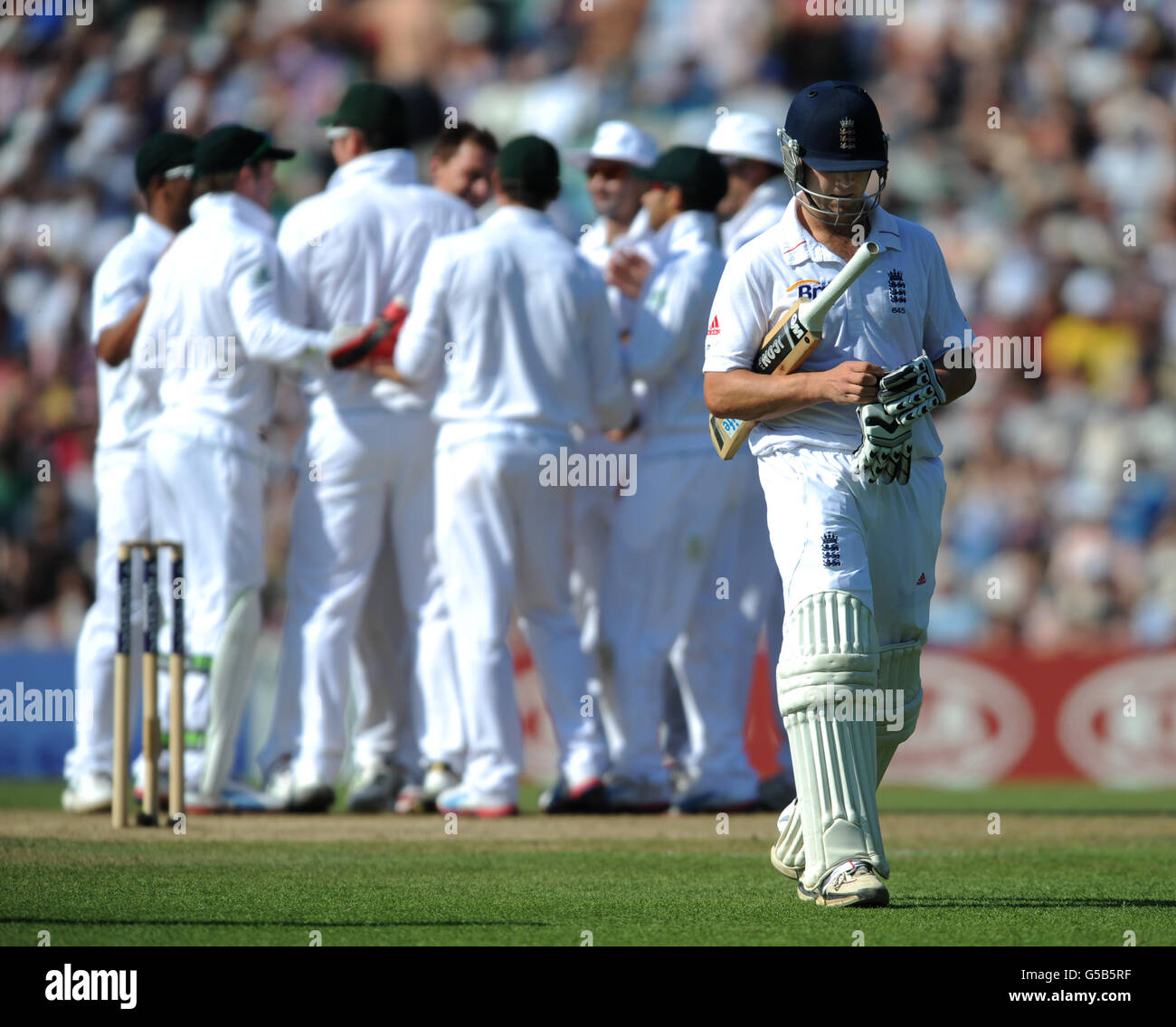 England's Jonathan Trott walks off after being caught by South Africa's ...