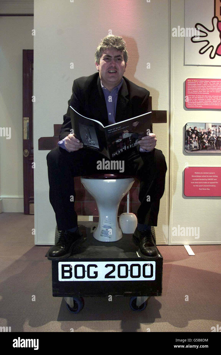 TV presenter Nick Hancock sitting on pop singer Robbie Williams ...