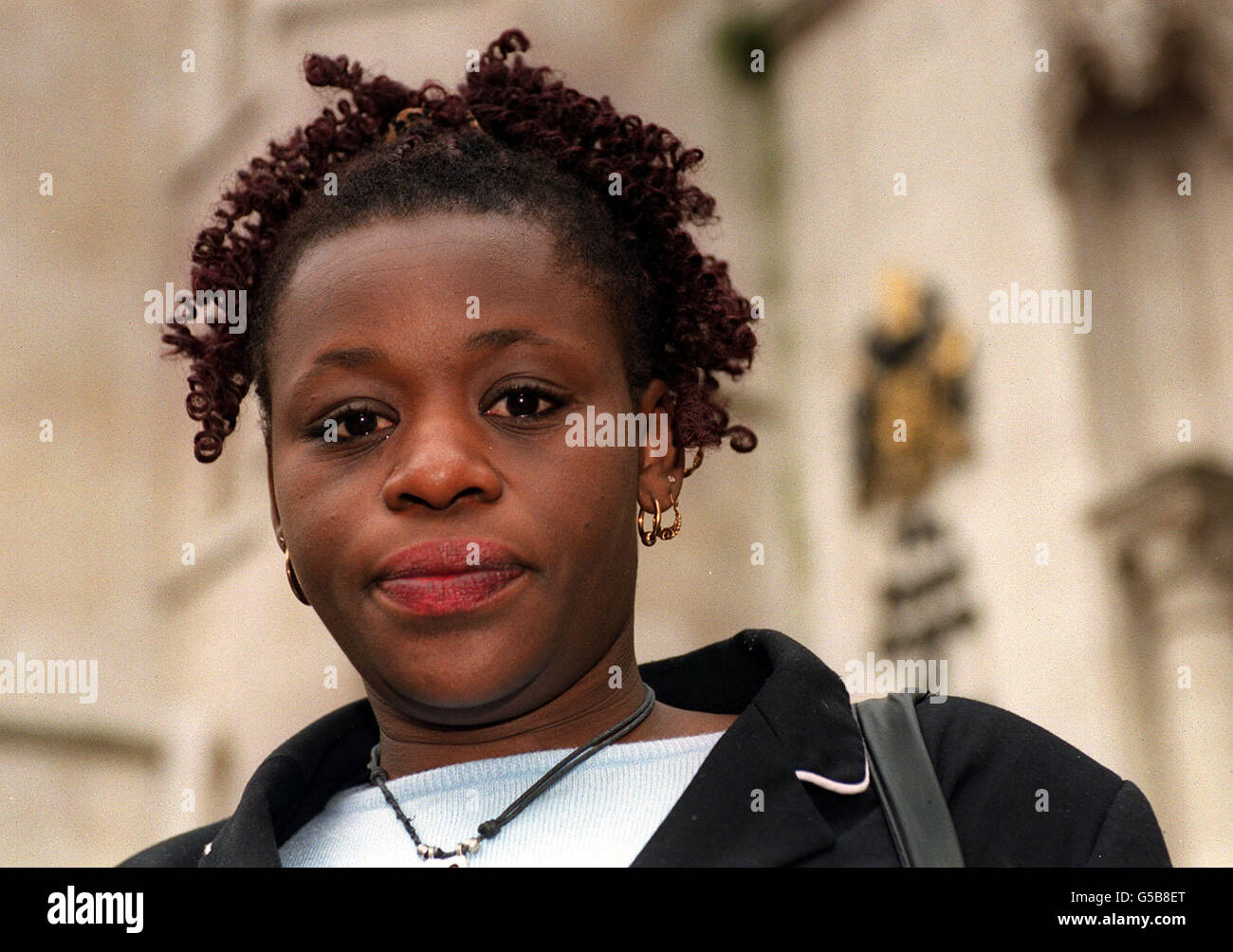 Hands cuffed behind back hi-res stock photography and images - Alamy