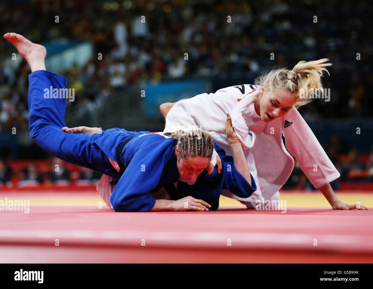 Great Britain's Sarah Clark (bottom) is thrown by France's Automne ...