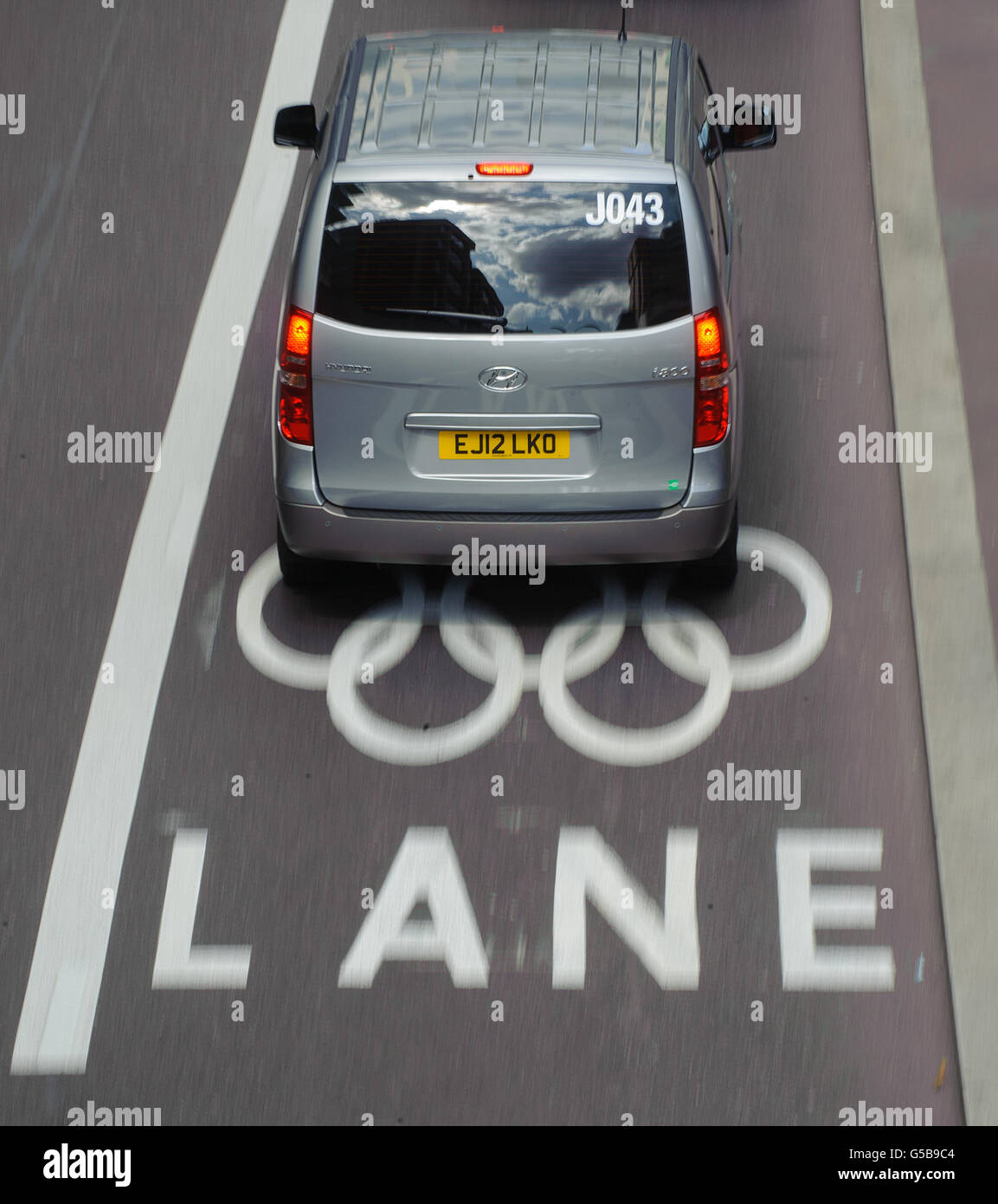An official Olympic vehicle drives in an Olympic traffic lane in ...