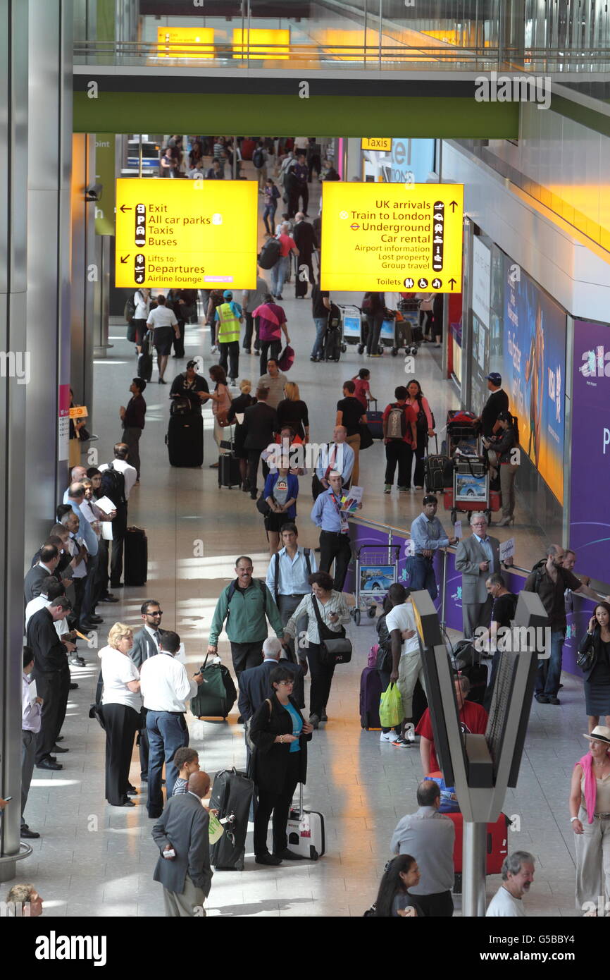 Friends and family wait for passengers to arrive at Terminal 5 of ...