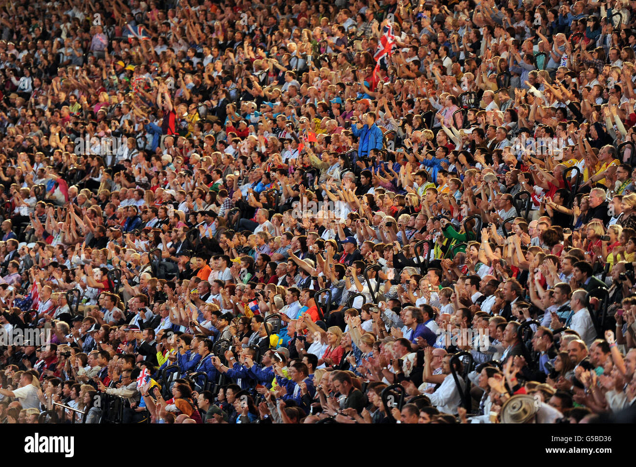 The crowd cheers during the London Olympic Games 2012 Opening Ceremony ...