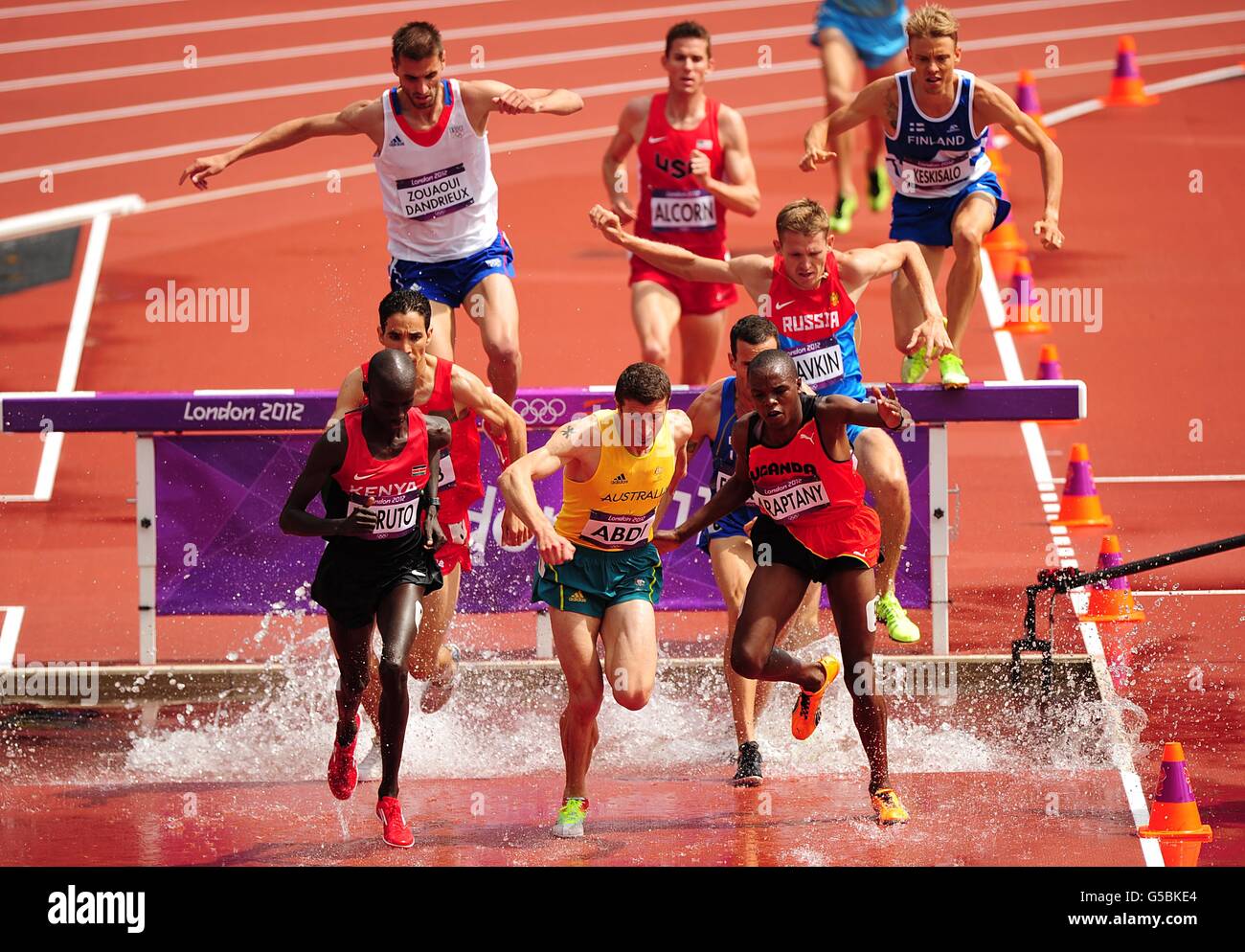 Competitors go over the water jump during heat 2 of Round 1 of the Men ...