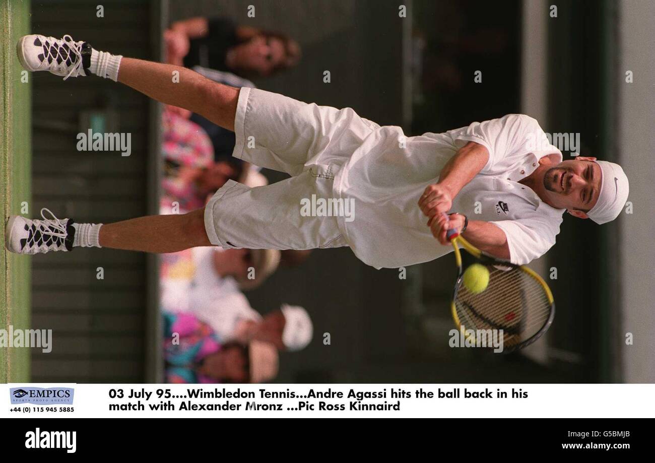 03 July 95. Wimbledon Tennis. Andre Agassi hits the ball back in his ...