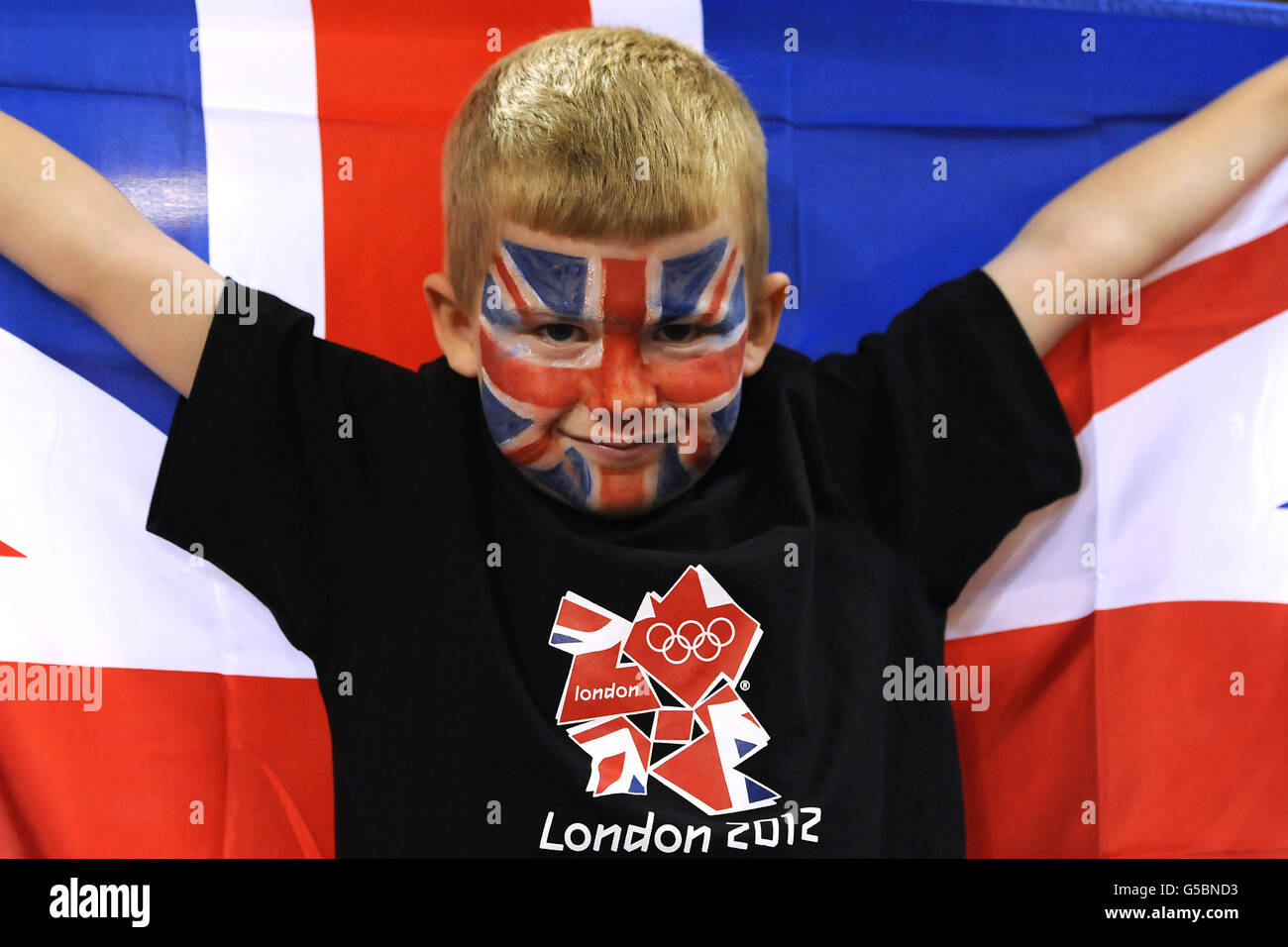 A Great Britain fan with painted face and a Union flag shows his ...