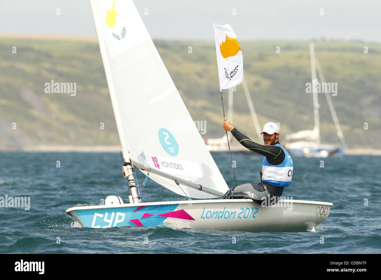 Cyprus's Pavlos Kontides celebrates winning silver in the Laser class ...