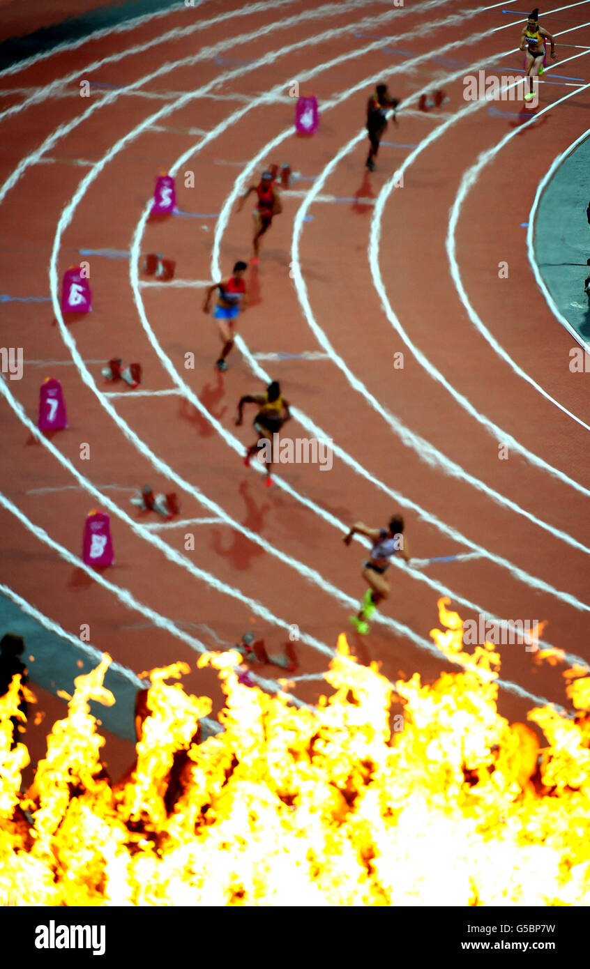 The Olympic Flame burns as athletes compete in the Women's 400m Hurdles ...