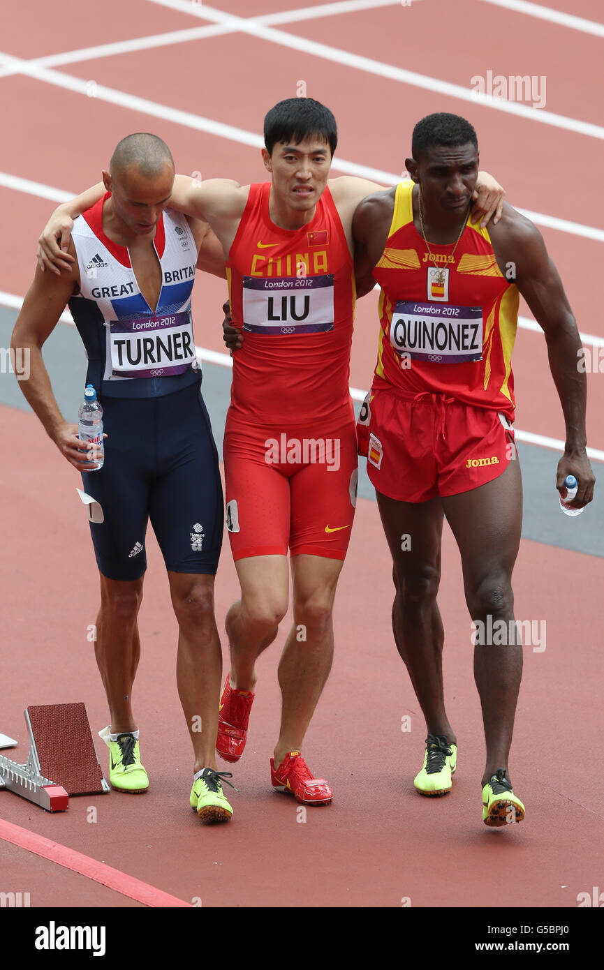 China's Liu Xiang is helped from the track by Great Britain's Andrew ...