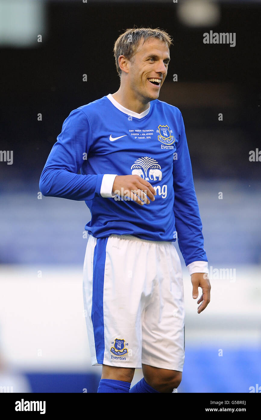 Everton's Phil Neville laughs as Tony Hibbert (out of pic) has a shot ...