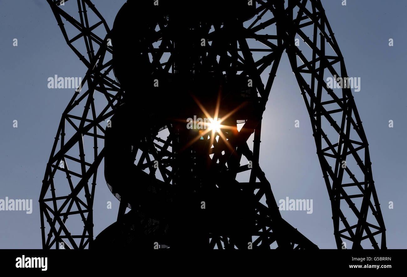The sun shines through The Orbit outside the Olympic Stadium on day 13 ...