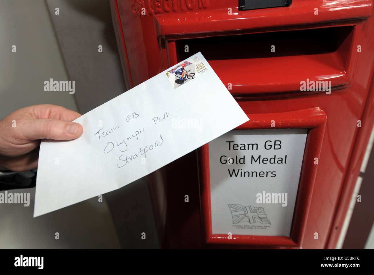 Veteran postman, Doug Mowatt, delivers a letter with a Royal Mail stamp ...