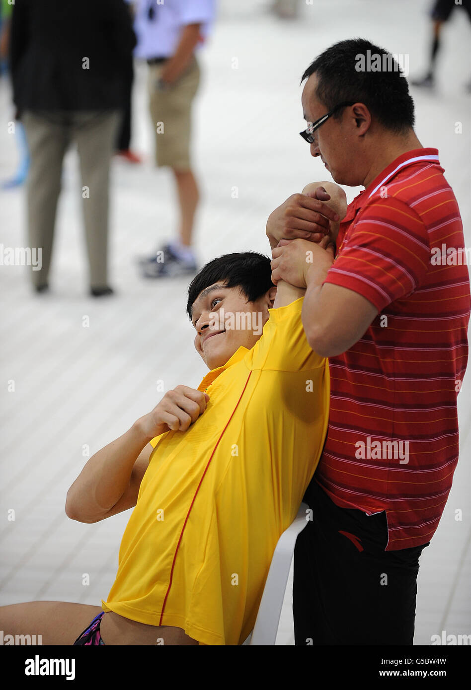 China's Sun Yang is helped with his stretches before he practices at ...