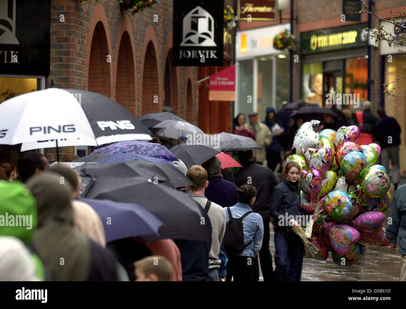 Wet bad weather queuing raining balloons umbrella hi-res stock ...