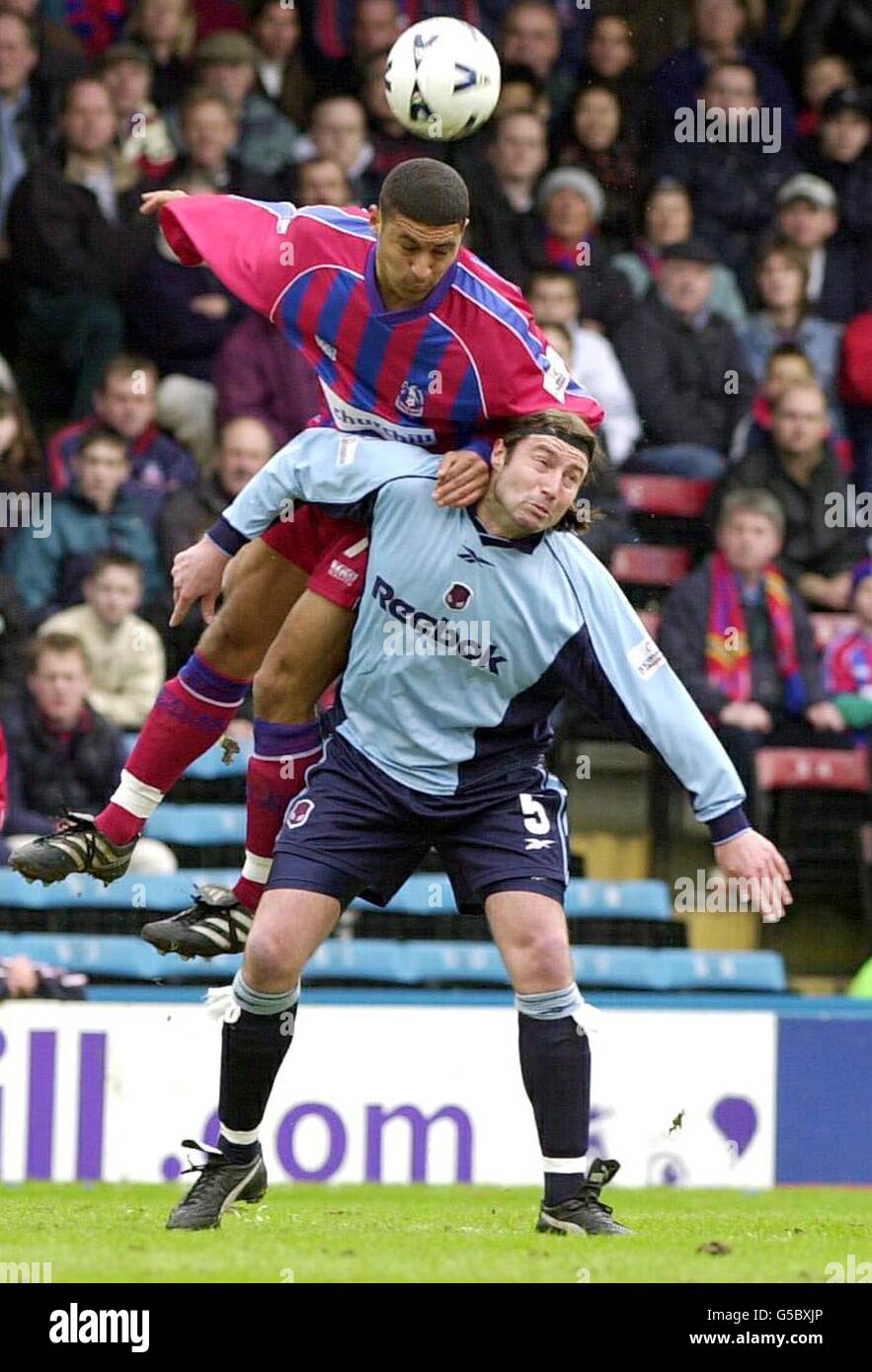 Bolton Wanderers's Paul Warhurst is leant on in a header by Crystal ...