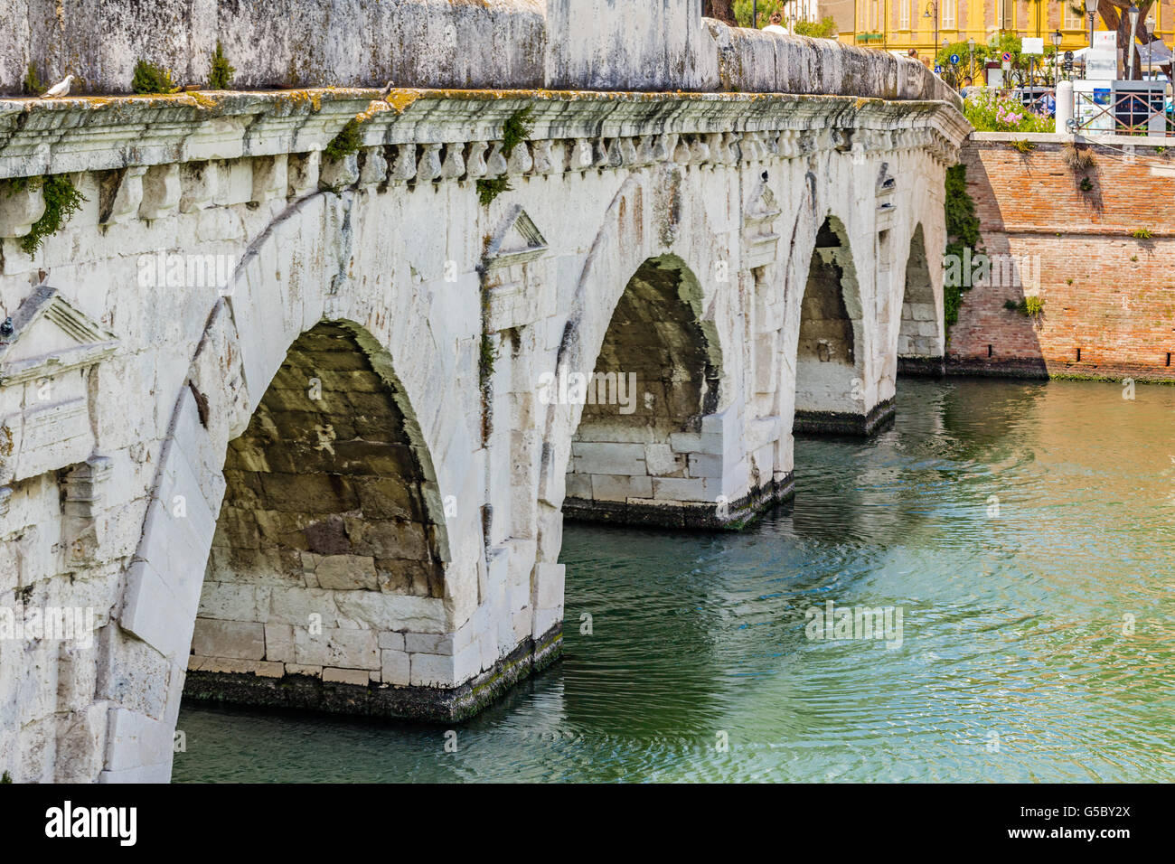 clear water under the arches of the Roman bridge of Augustus Stock ...