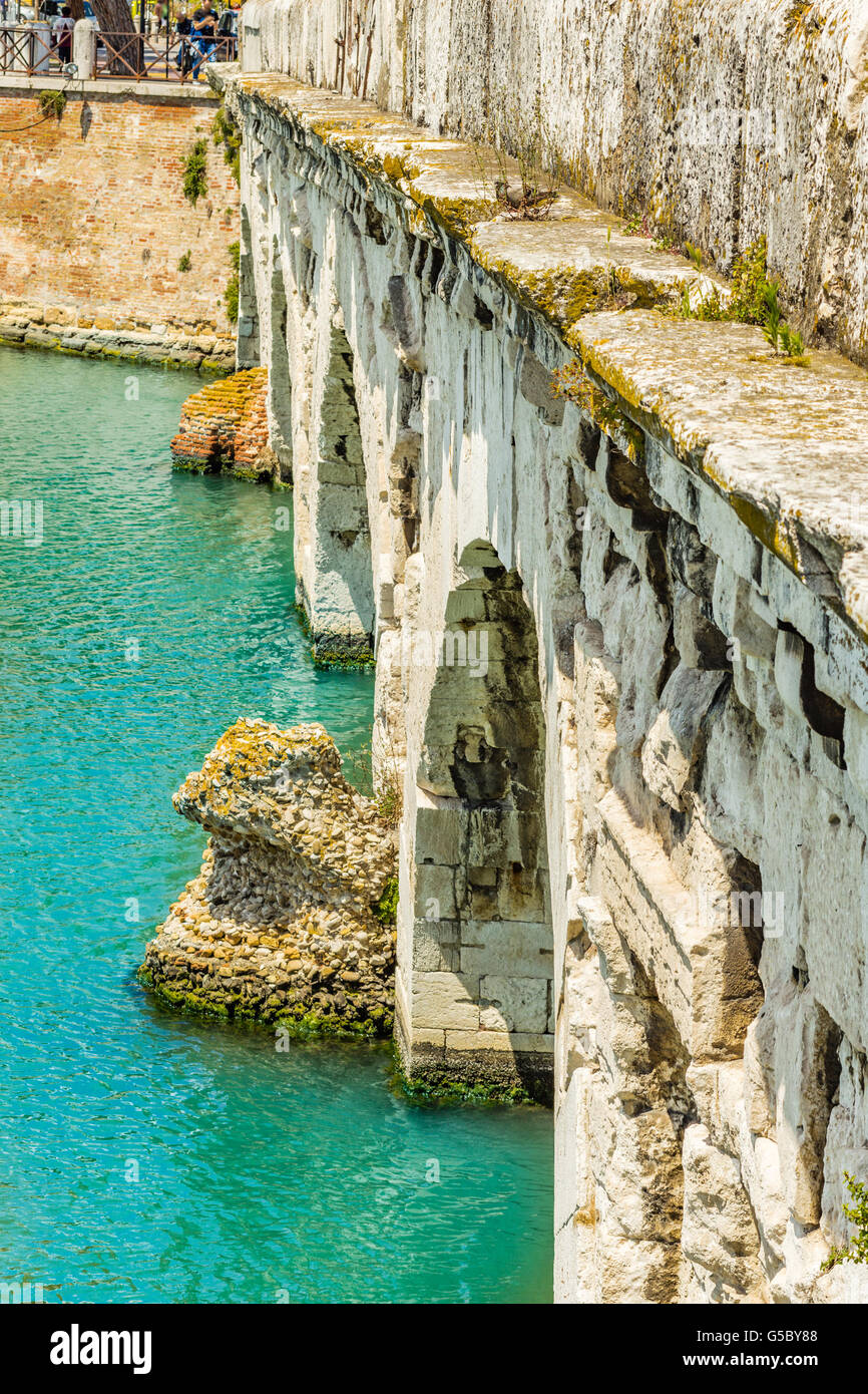 clear water under the arches of the Roman bridge of Augustus Stock ...