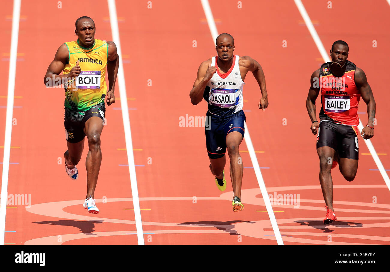 Jamaica's Usain Bolt (left) runs next to Great Britain's James Dasaolu ...