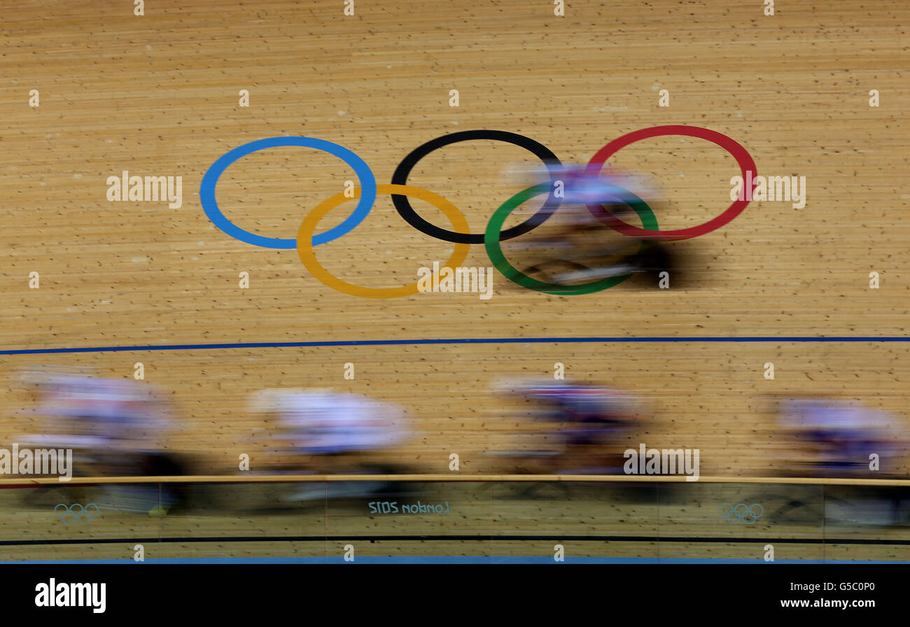 Riders in the Men's Omnium go past the Olympic Rings at the Velodrome ...